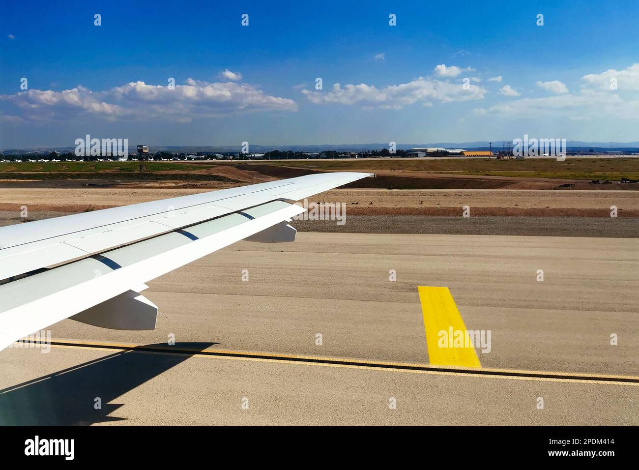 View from window of aircraft on wing and runway. Airplane getting ready ...