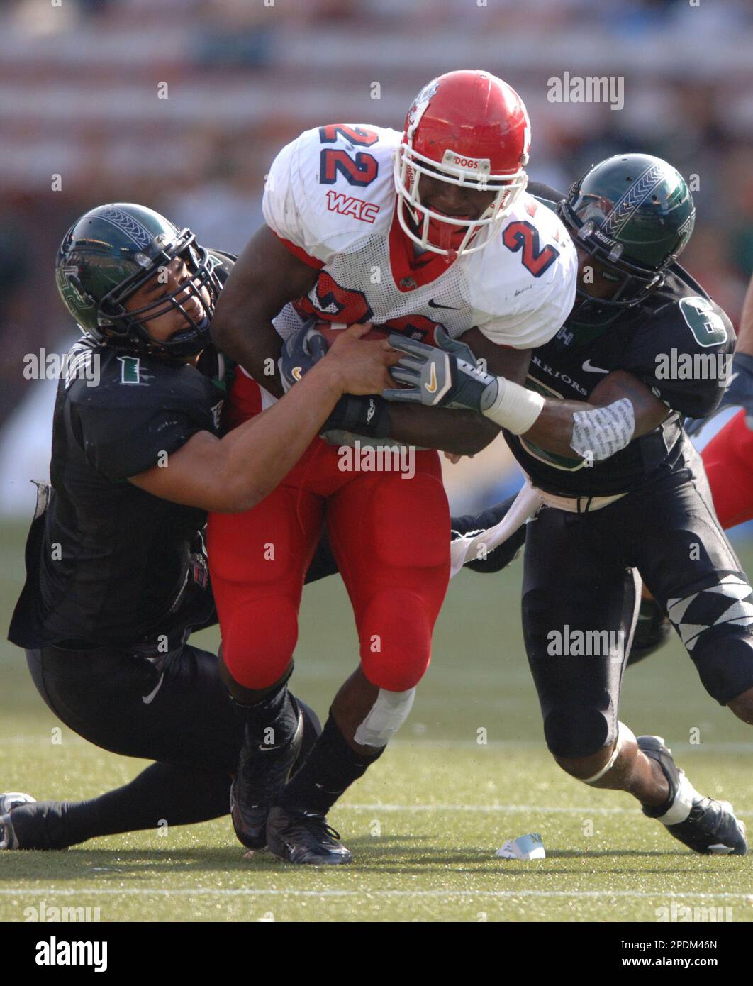 Fresno State's Wendell Mathis (22) breaks loose from two Hawaii ...