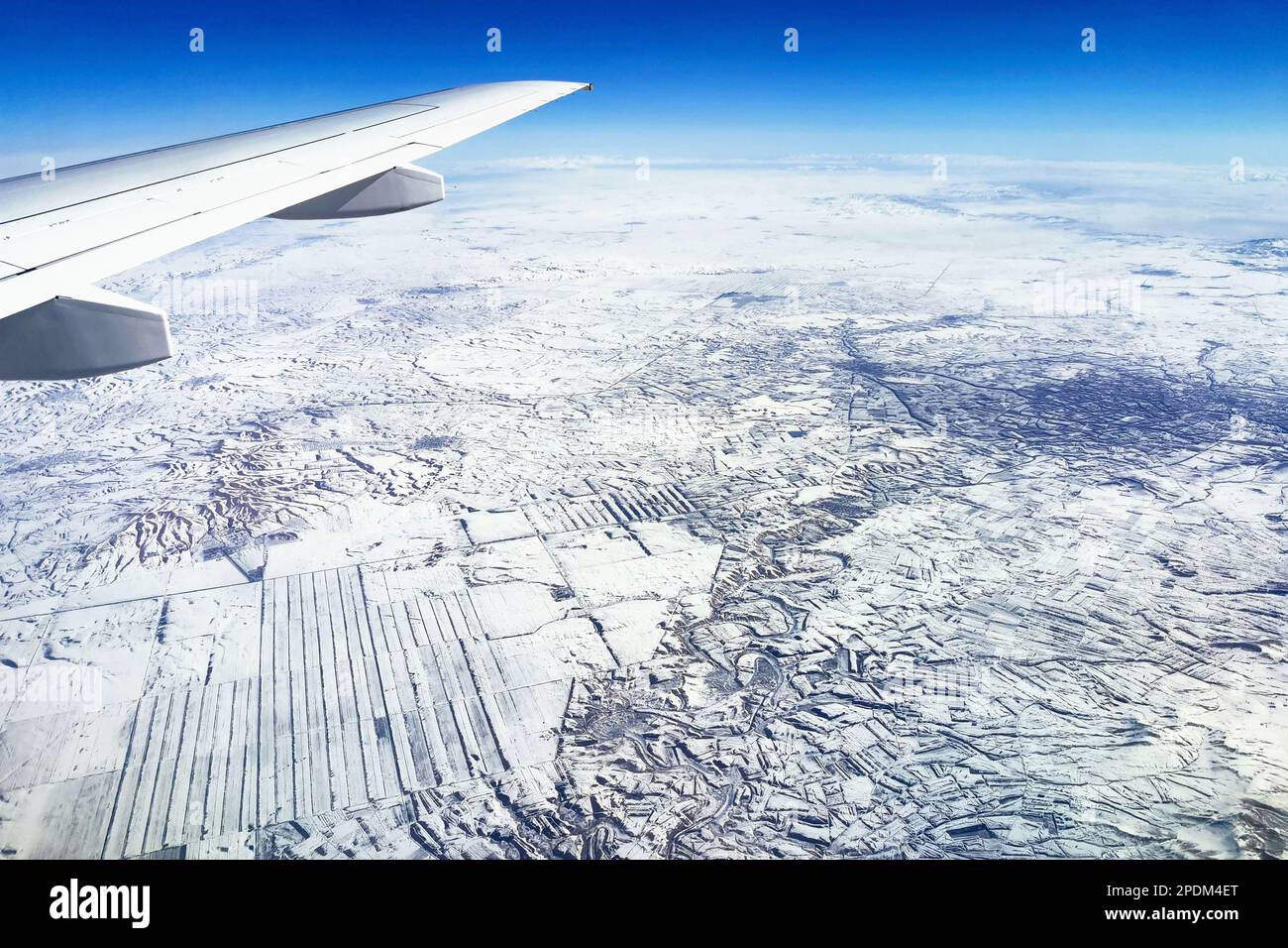 Aerial view through frozen porthole of snowy plains. Scenic view ...