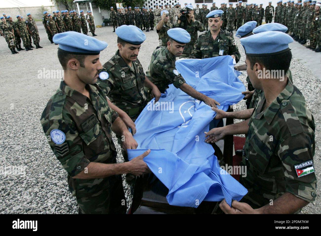 U.N. Jordan peacekeepers drape the U.N. flag on the coffin of U.N ...