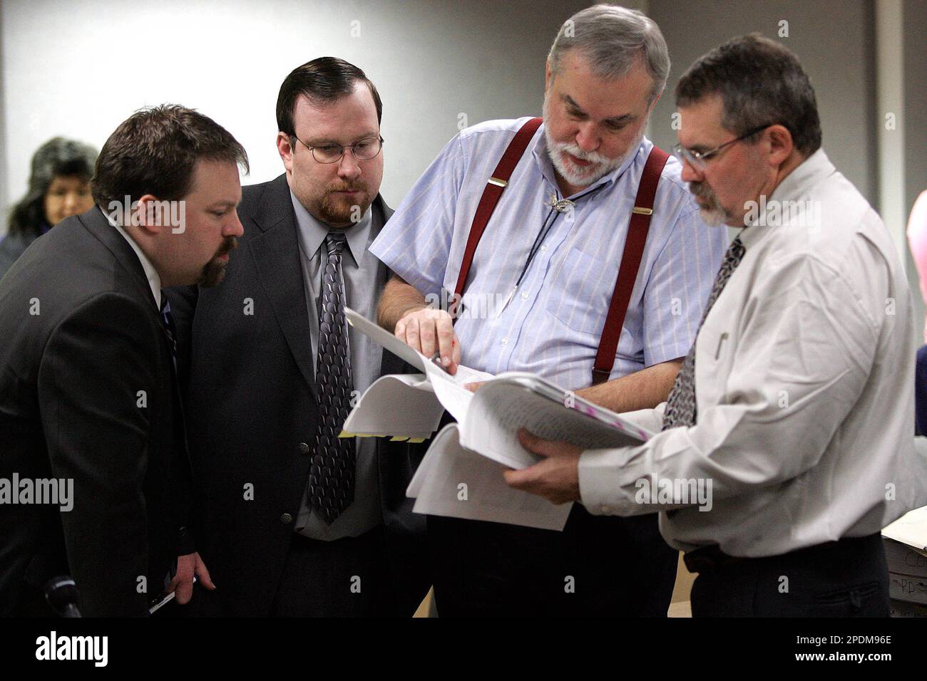 Former Nome police officer Matthew Owens, second left, watches with his ...