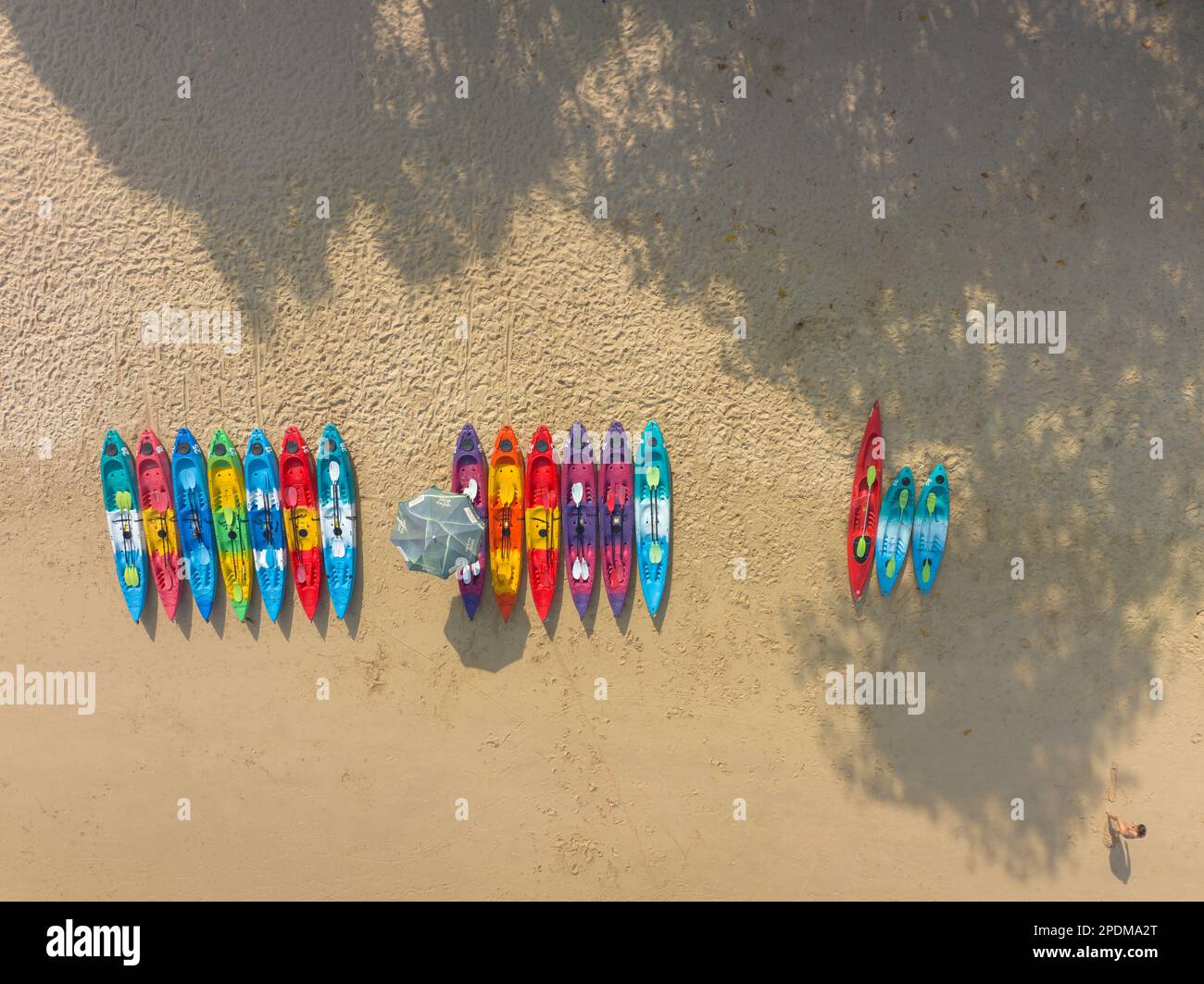 Aerial top view Colorful canoes are lined up in front of the beach. The ...