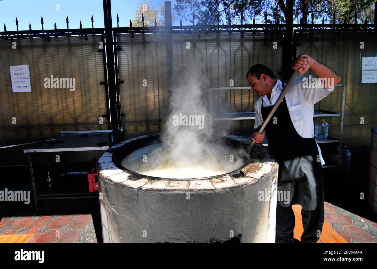 Giant cauldrons overflow with Uzbekistan's favorite rice dish at the ...