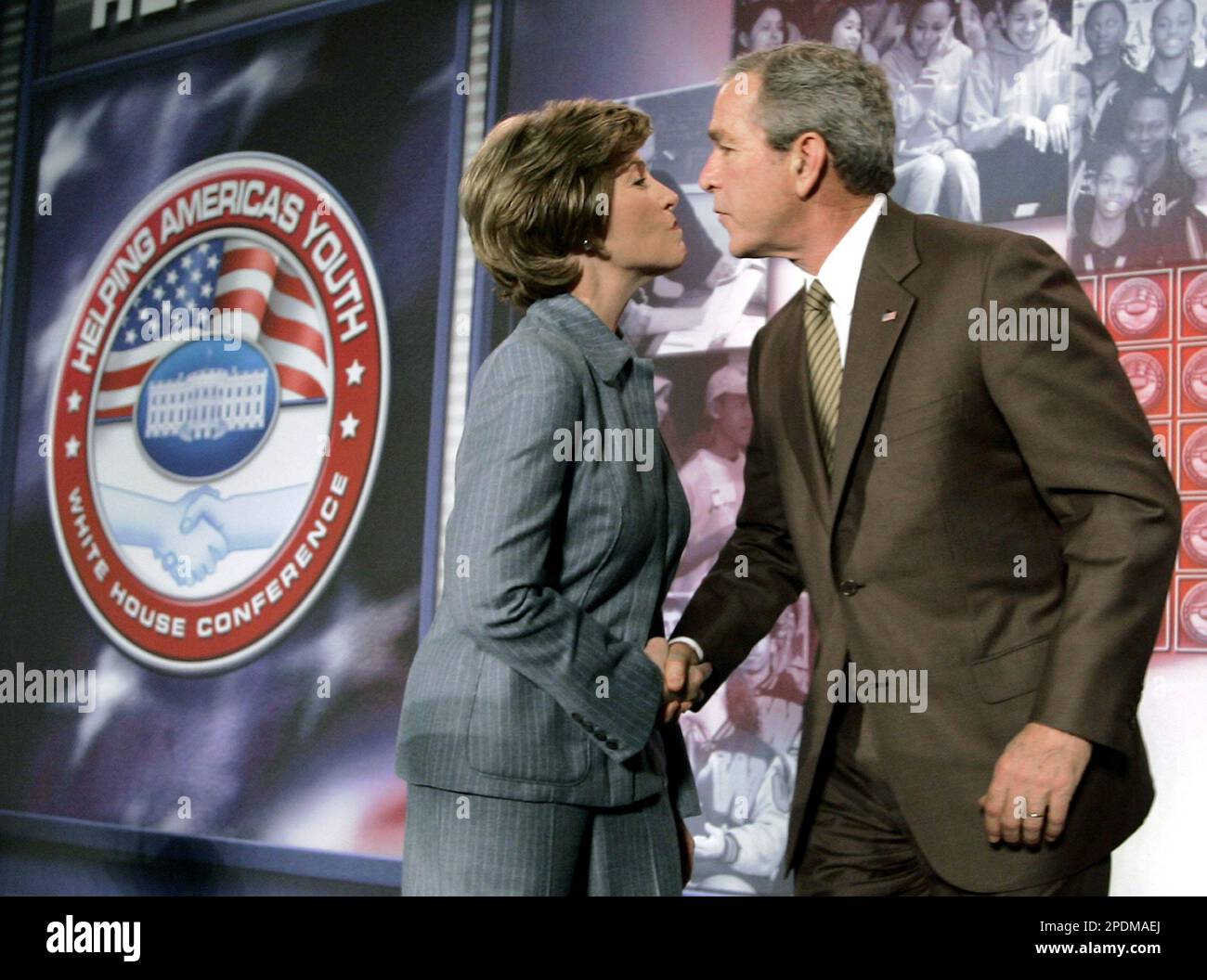 President Bush leans over to kiss first lady Laura Bush after she spoke ...
