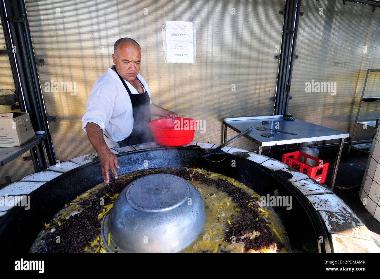 Giant cauldrons overflow with Uzbekistan's favorite rice dish at the ...