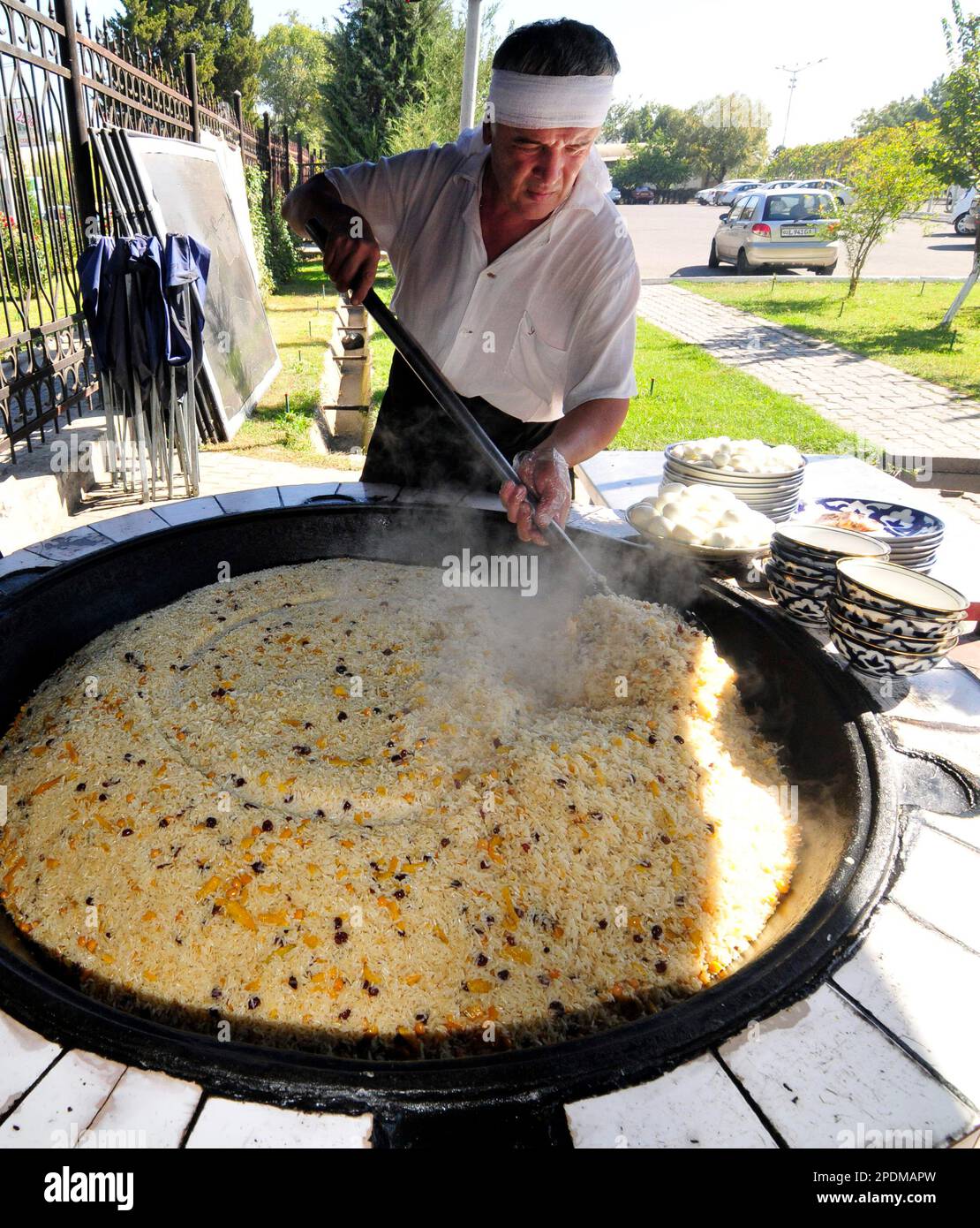 Giant cauldrons overflow with Uzbekistan's favorite rice dish at the ...