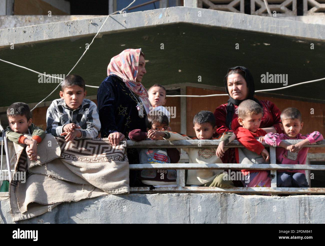 Iraqi children look at the scene of a bomb attack after a car bomber ...