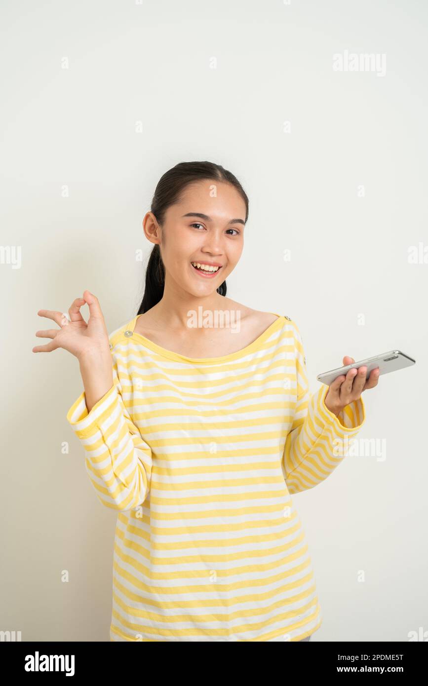 Young Aisan gril over isolated white background surprised and sending a ...