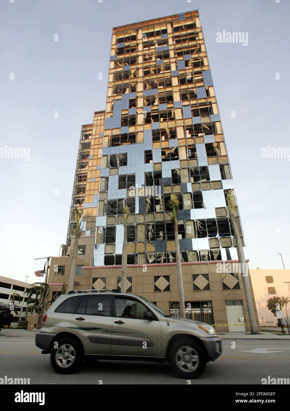 A car drives past one of several office buildings that were damaged ...