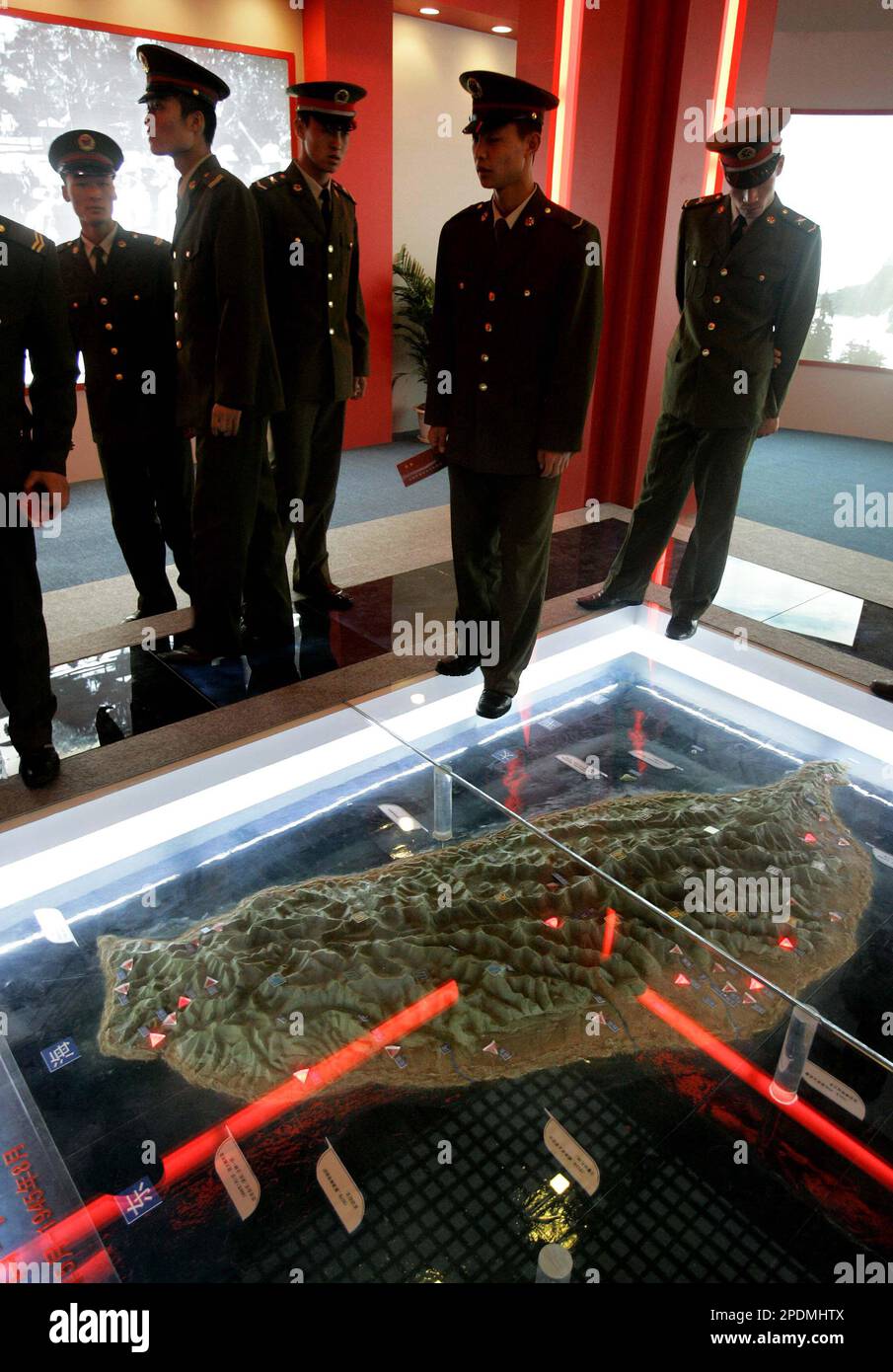 Chinese soldiers walk near a 3 dimensional map of Taiwan as they attend ...