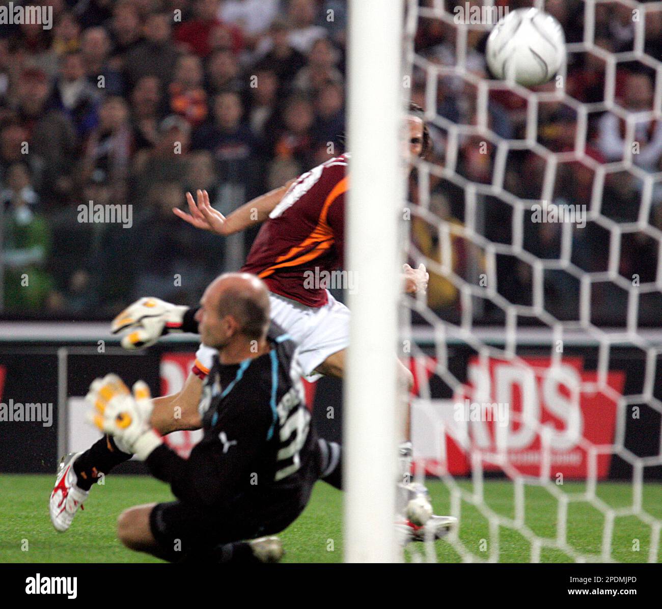 Roma's captain Francesco Totti, right, scores for his team during the ...