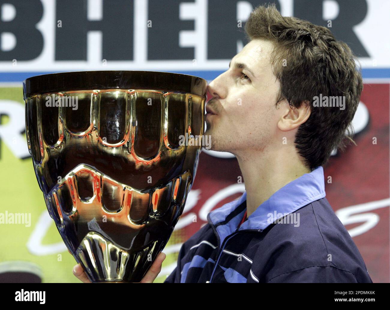 Timo Boll of Germany kisses his trophy as he wins the final of the Men ...