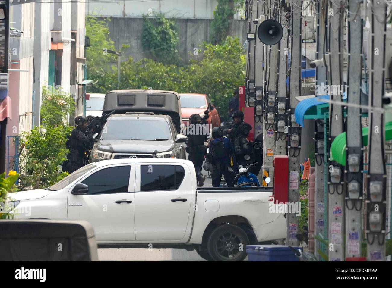 A group of armed commando police are seen outside the home of a senior ...