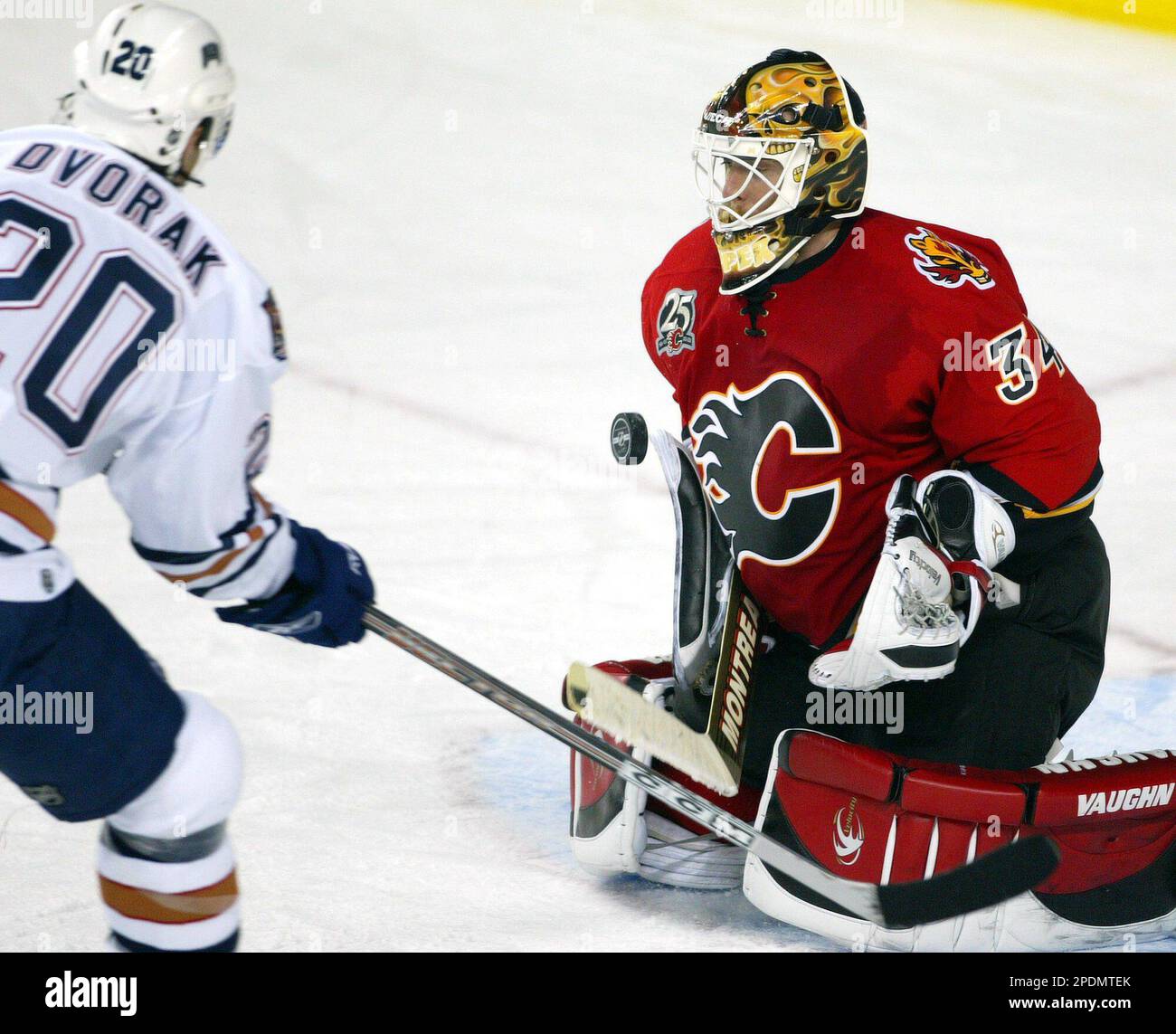 Calgary Flames goalie Miikka Kiprusoff , right, makes a save on ...