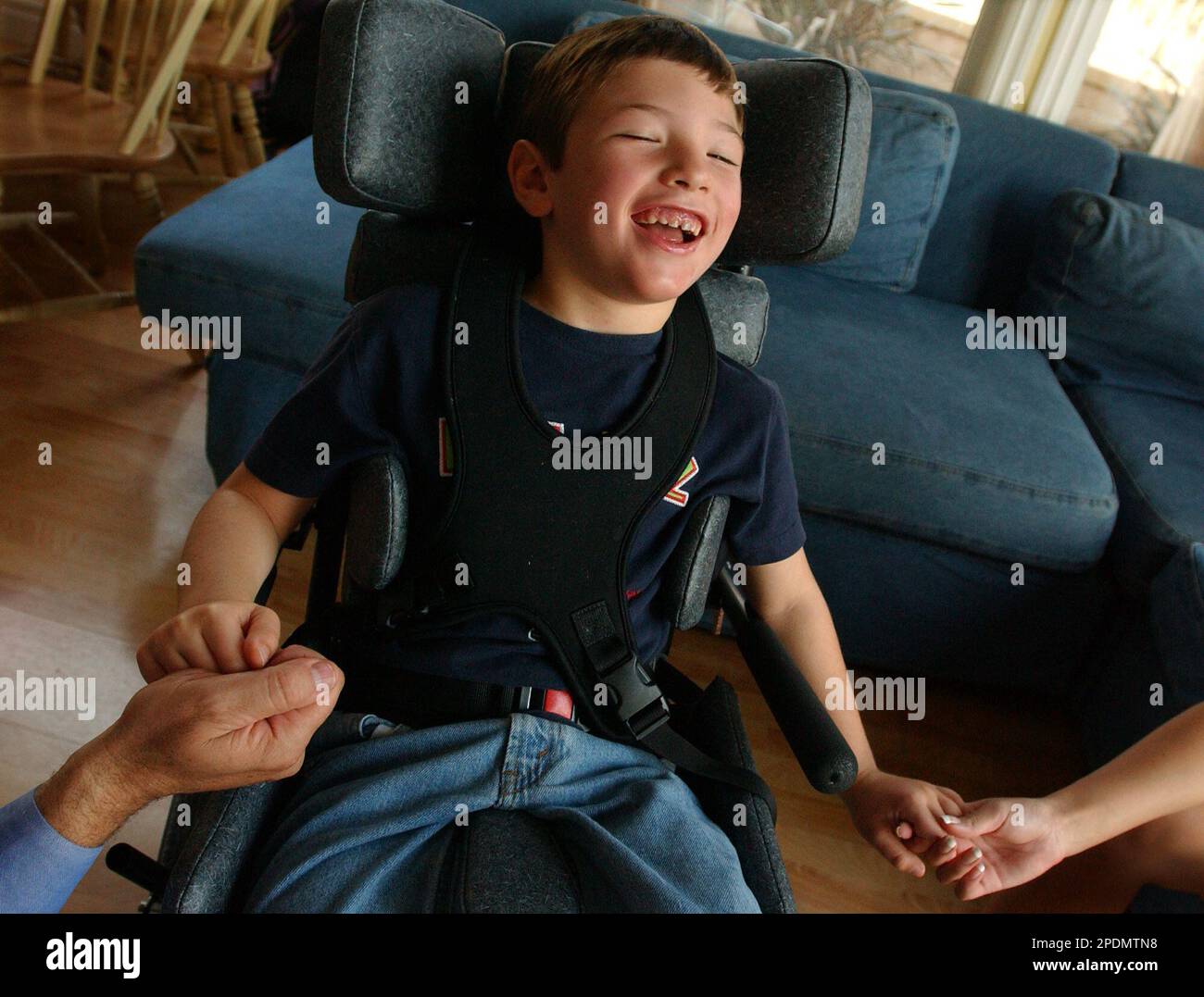 Daniel Kerner, a 5-year-old Battens disease patient, holds hands with ...