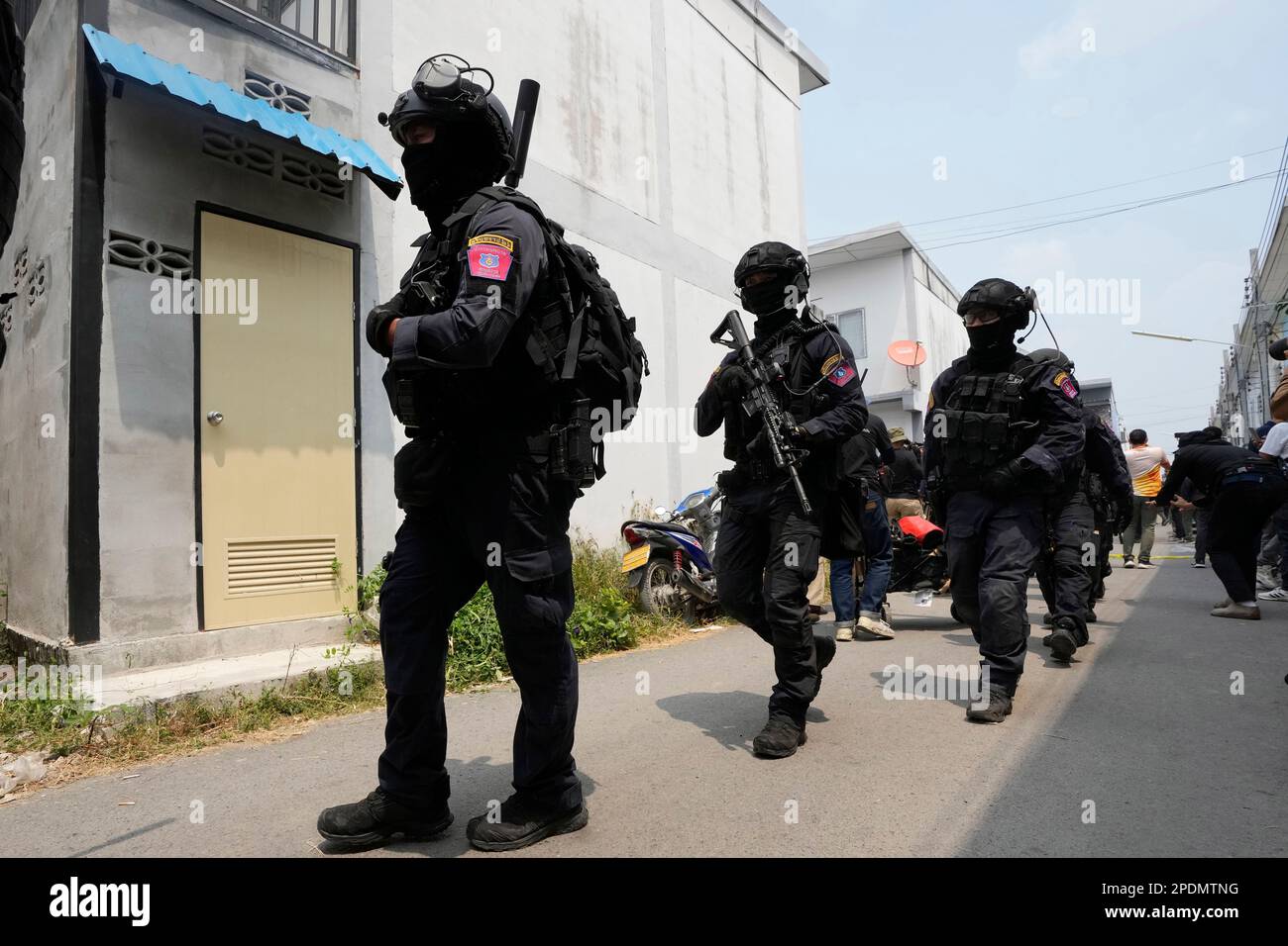 A group of armed commando police leave from the home of a senior police officer in Bangkok ...