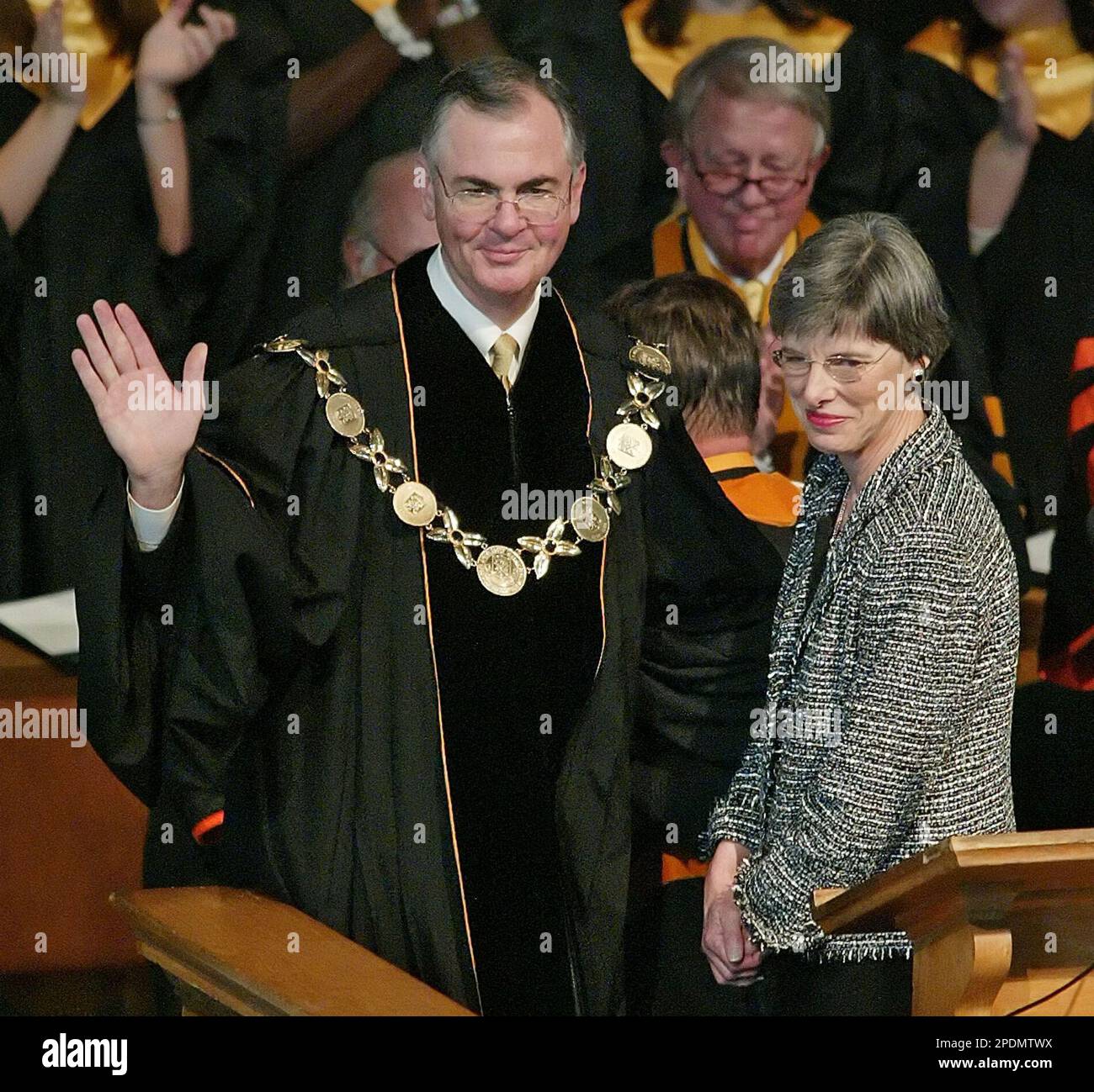 Nathan O. Hatch stands with his wife, Julie, and waves to the audience ...