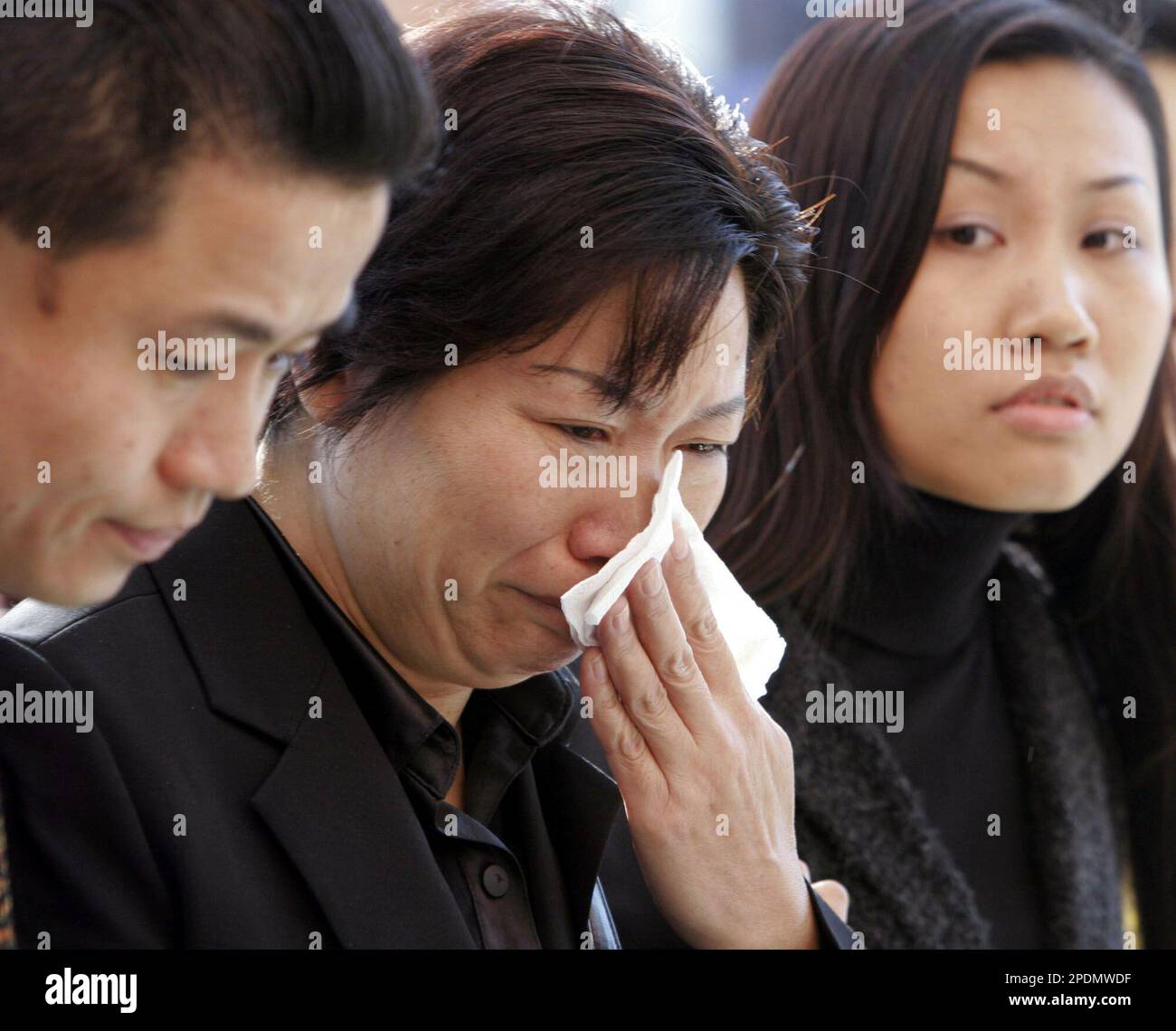 City Councilman John Liu, left, escorts Xiu Mei Wei, center, and her ...