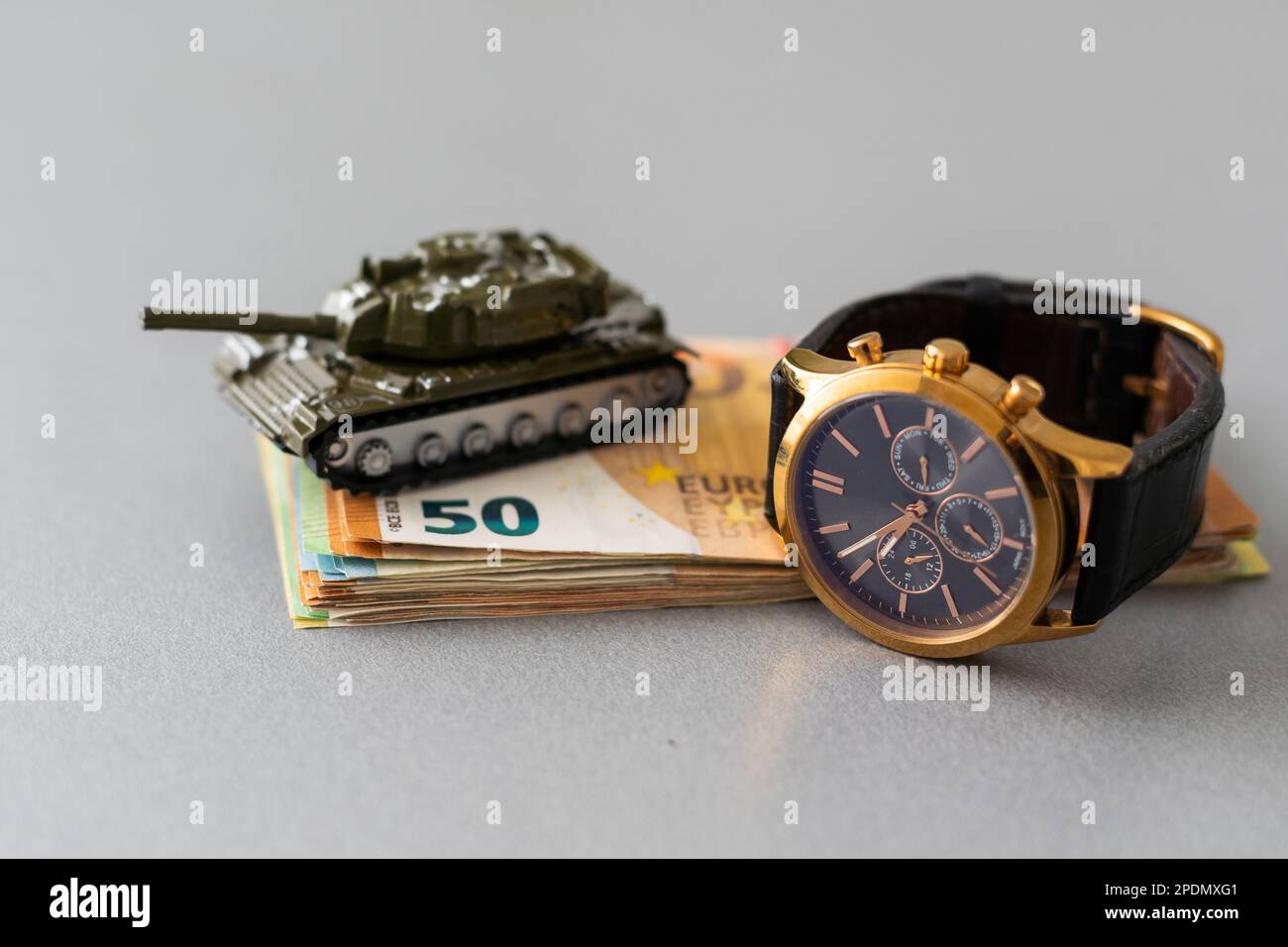 The concept of financing war and armaments. toy tank, euro, clock Stock ...