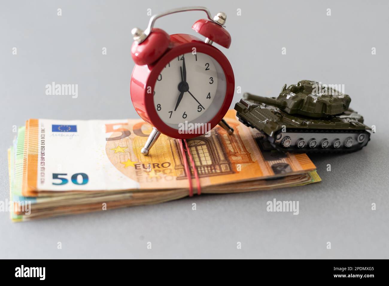 War financing concept, toy tank, euro, clock Stock Photo - Alamy