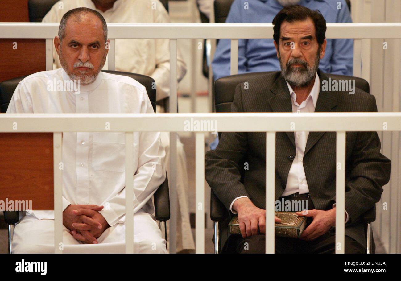 Saddam Hussein, right, and Awad Hamad al-Bandar, former chief of the ...