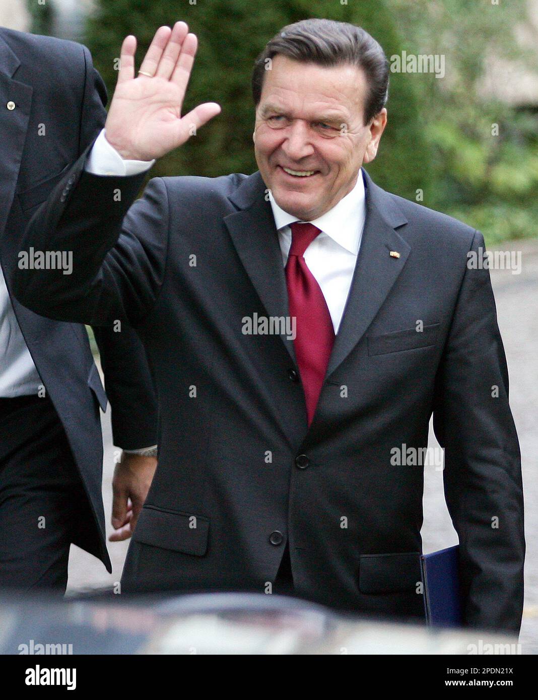 Outgoing German Chancellor Gerhard Schroeder waves on his way to his ...
