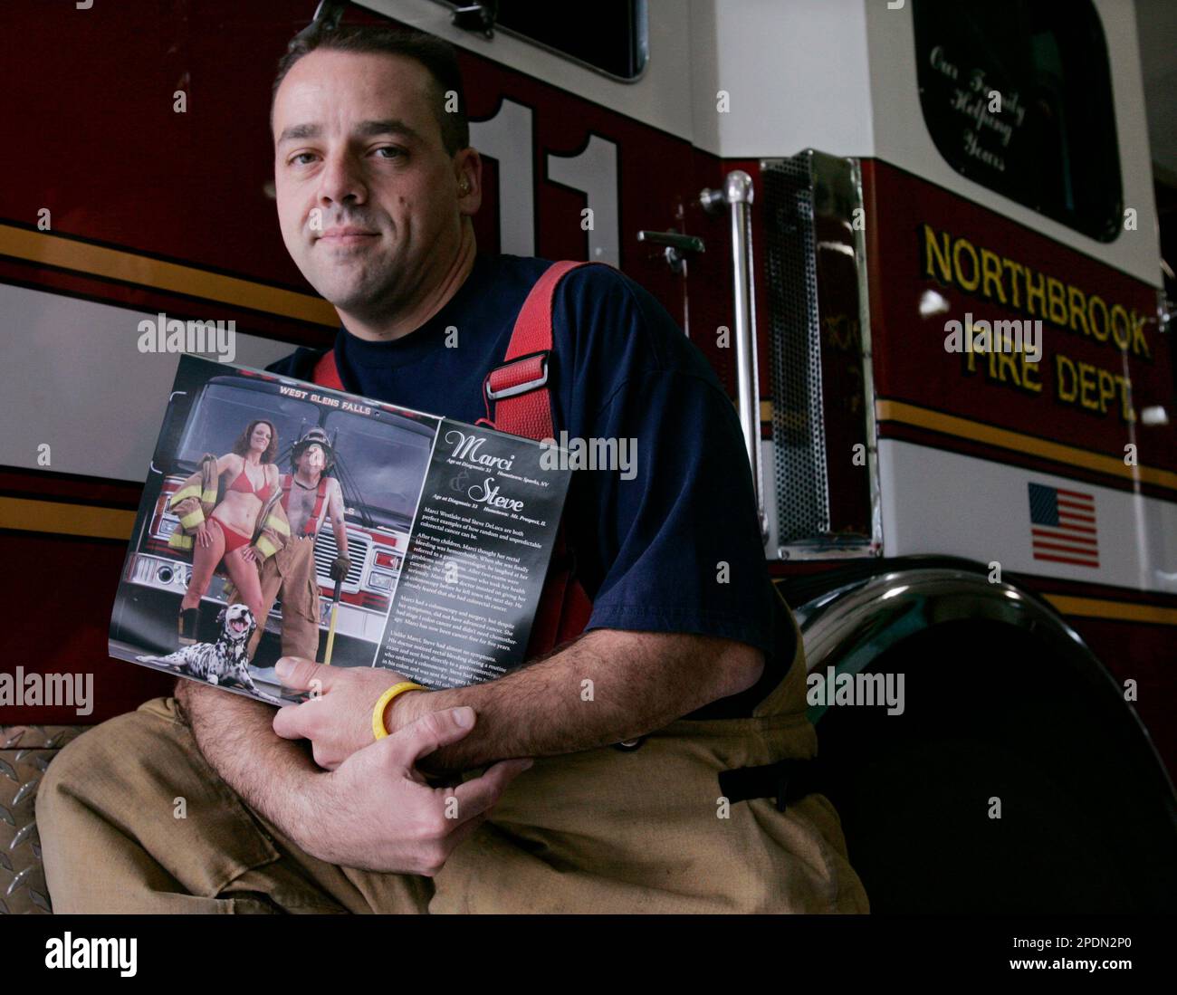 Firefighter Steve DeLuca holds a copy of the 2006 "Colondar" calendar ...