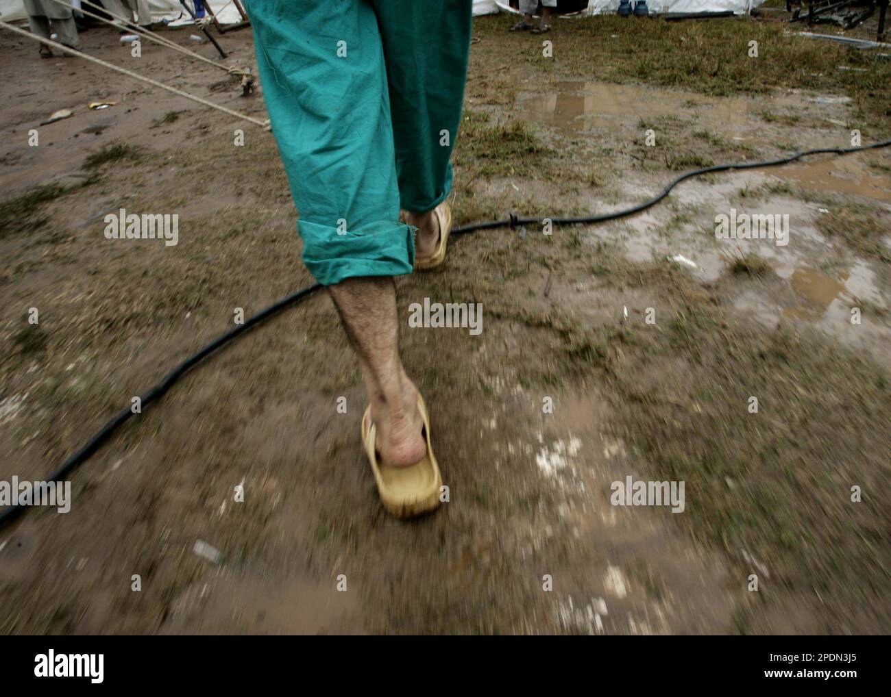 Pakistani Dr. Intisar Rashid, wearing plastic sandals wades through ...