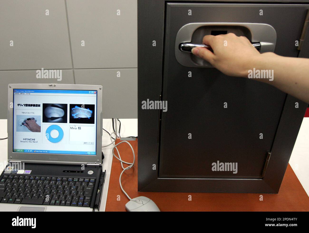 A Hitachi Ltd. employee grips the door handle to open the door during a demonstration of its new ...