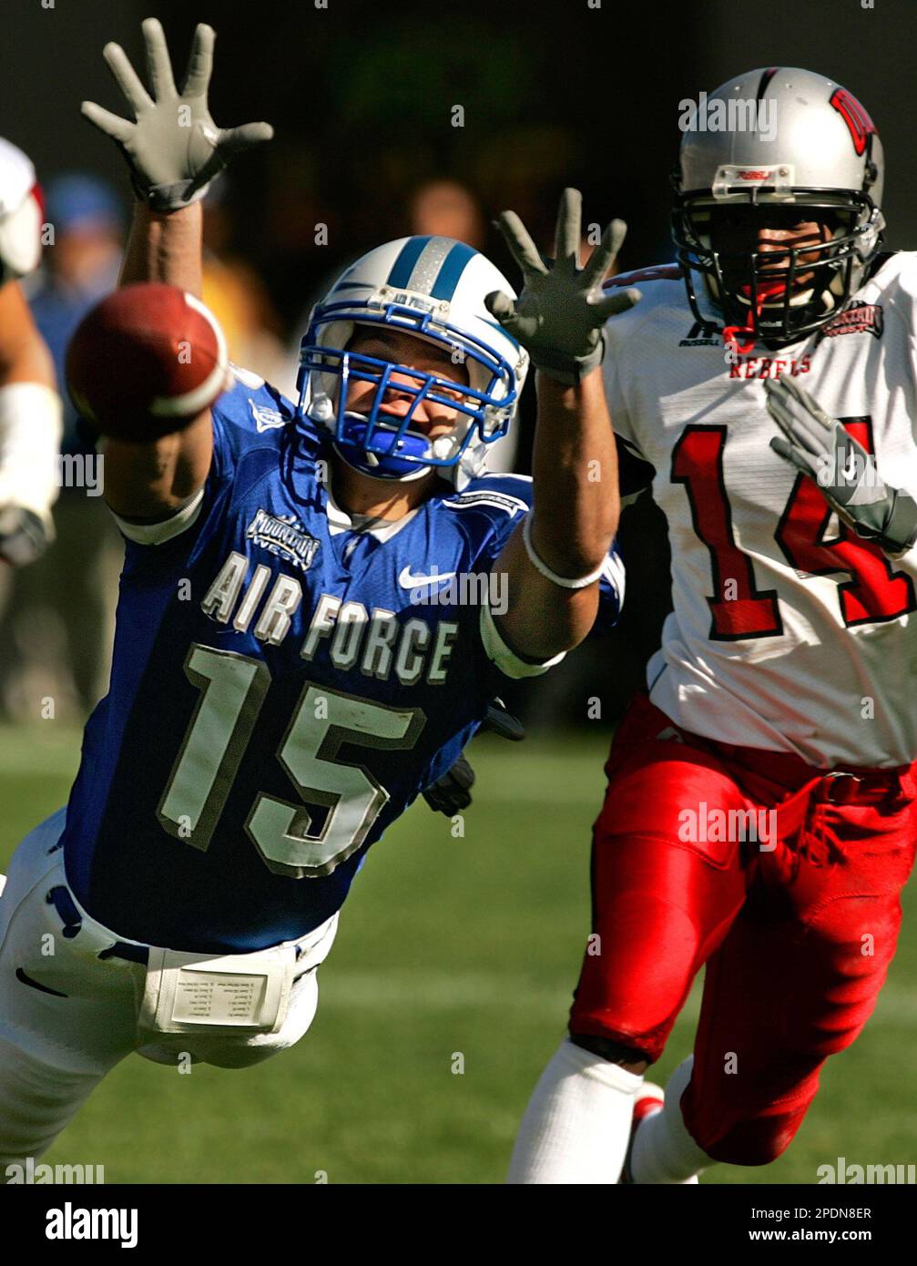 Air Force halfback Jim Ollis, left, dives to reach a pass as UNLV ...