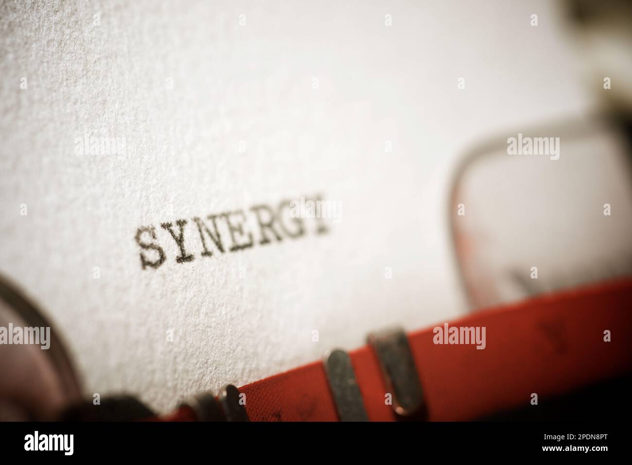 Synergy word written with a typewriter Stock Photo - Alamy