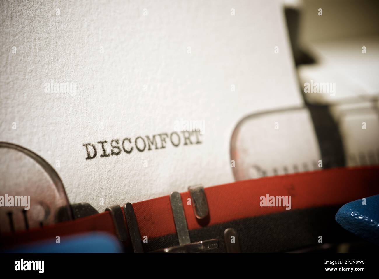Discomfort word written with a typewriter Stock Photo - Alamy