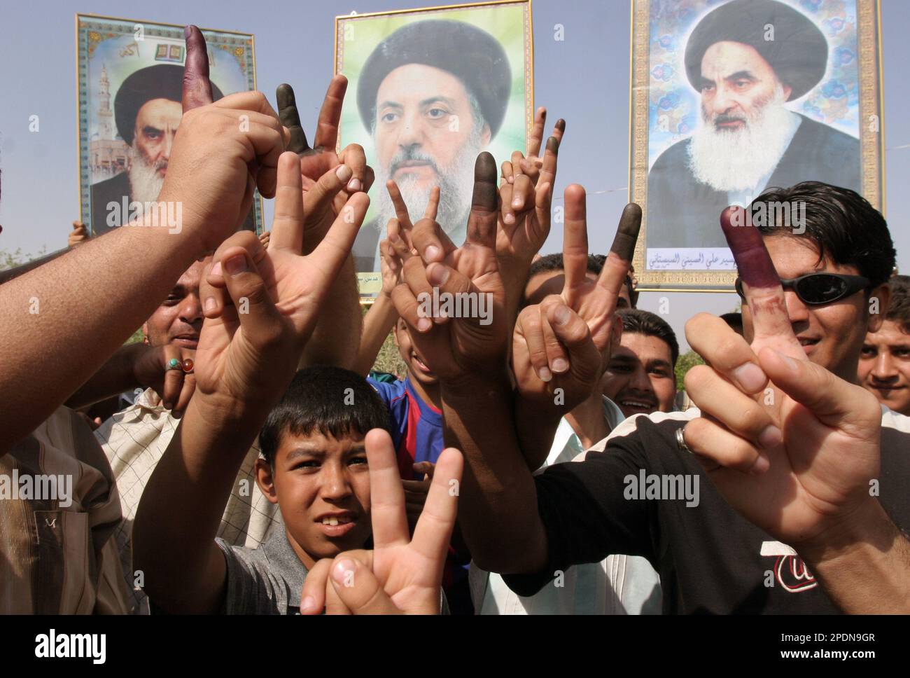 Iraqi Shiites flash victory signs, showing off their ink marked fingers ...