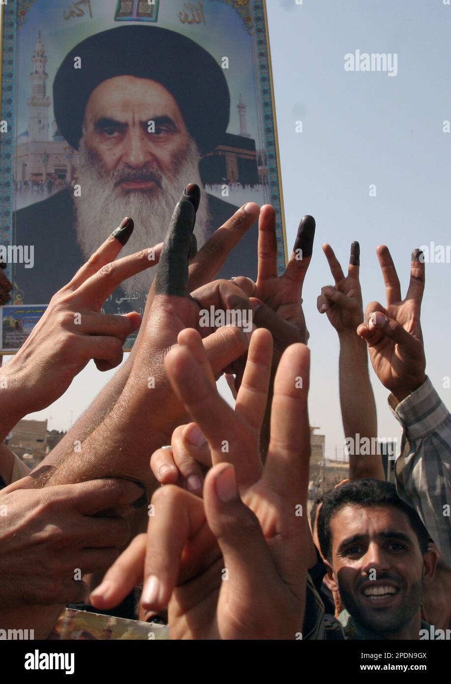 Iraqi Shiites flash victory signs, showing off their ink marked fingers ...