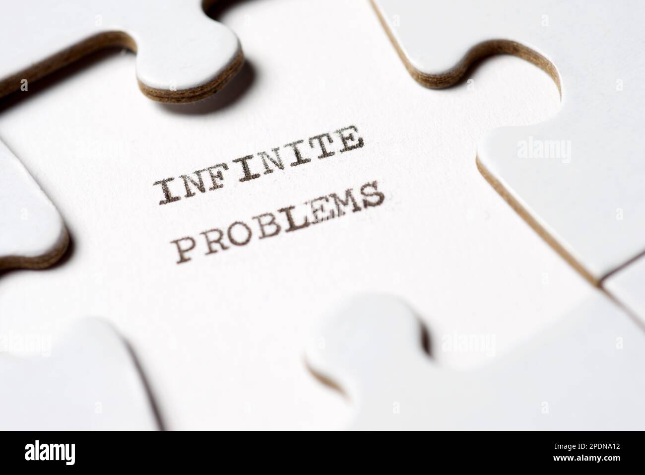 Infinite problems text written with a typewriter in a white puzzle ...