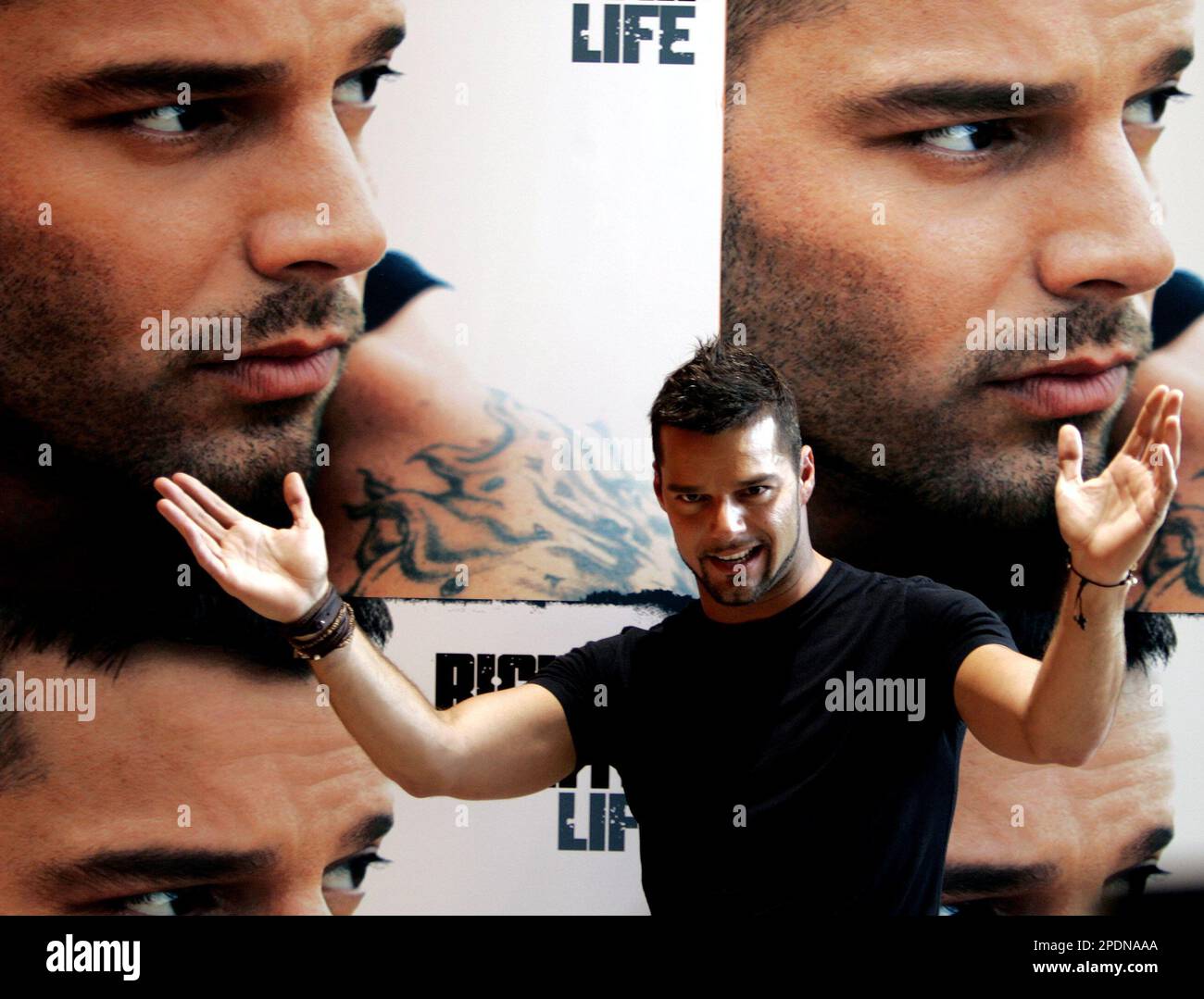 Musician Ricky Martin gestures in front of a backdrop promoting his new ...