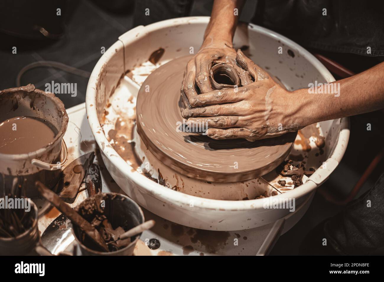 Master of pottery hancraft work modeling hand made clay on potter wheel ...