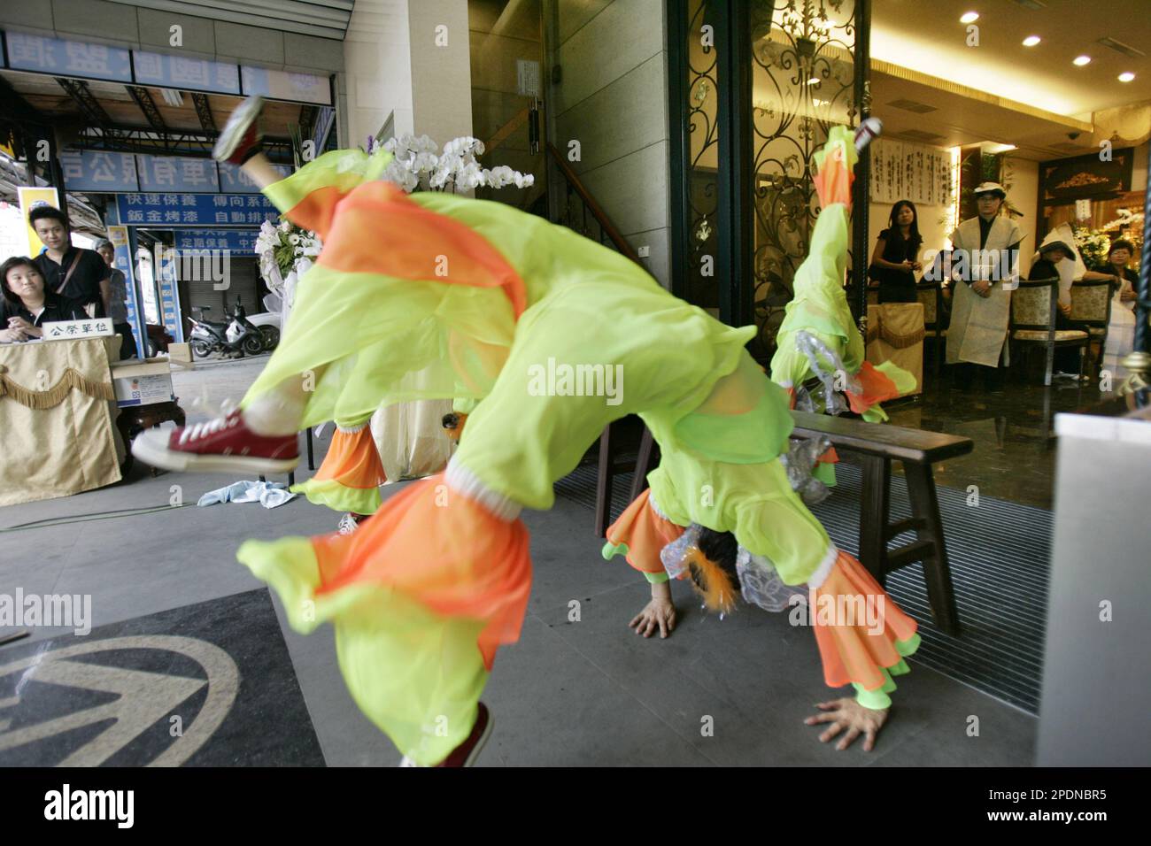 Members of the "Filial Daughters' Band" perform acrobatics during a ...