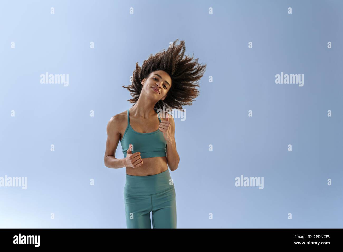 Active sporty woman in sportswear jumping on studio background. Sport ...
