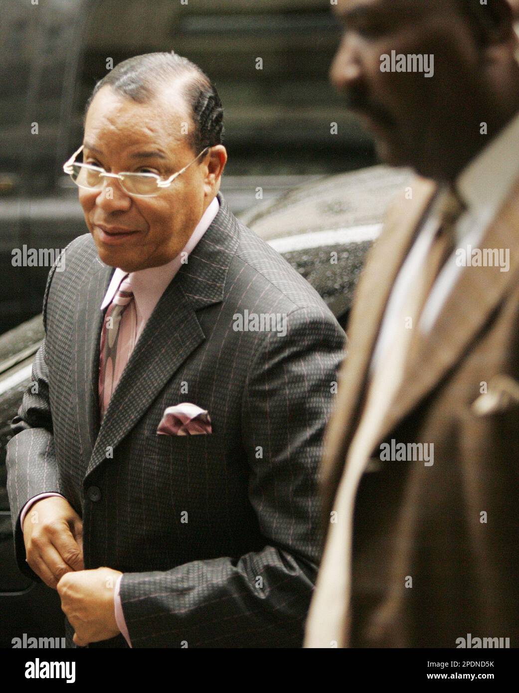 Nation of Islam leader Louis Farrakhan, center, is escorted by a member ...