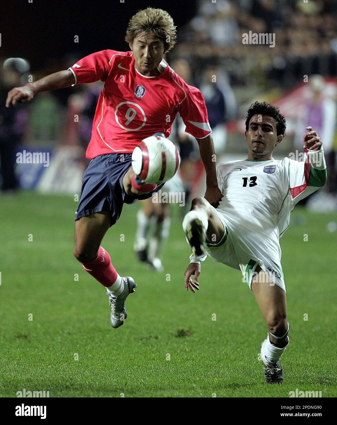 South Korea's Lee Chun-soo, left, fights for the ball against Iran's ...