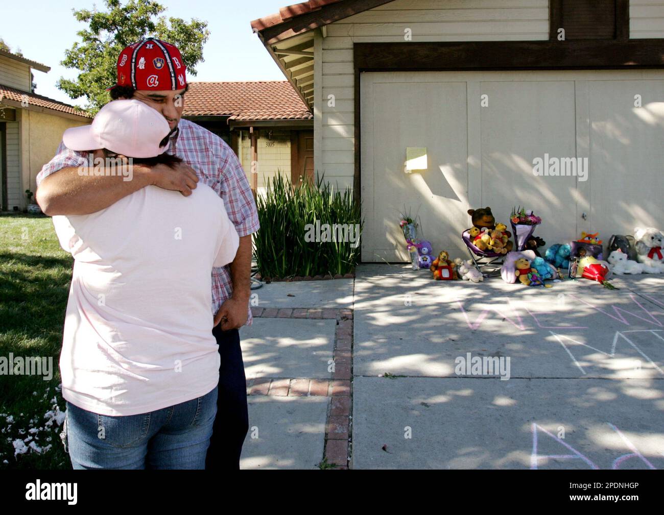 Daniel Gutierrez Jr., hugs a friend outside a house in San Jose, Calif ...