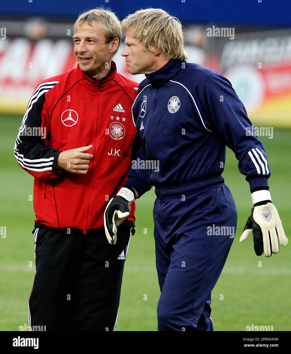 German national soccer-coach Juergen Klinsmann, left, jokes with goalie ...
