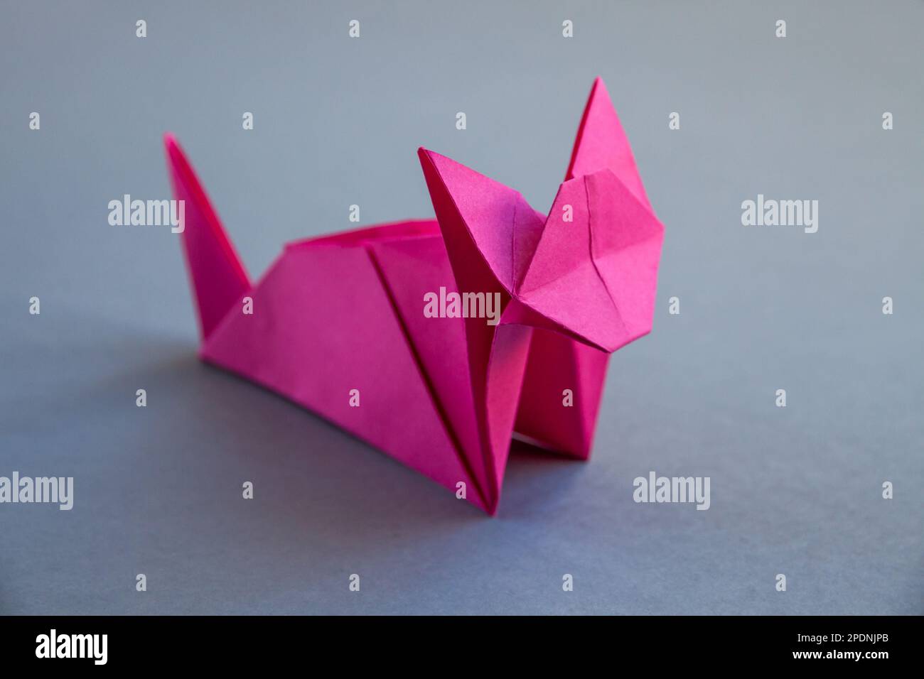 Pink paper cat origami isolated on a blank grey background Stock Photo ...