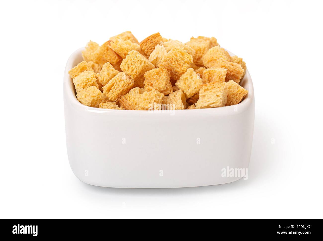 Crispy croutons in bowl isolated on white background with clipping path ...