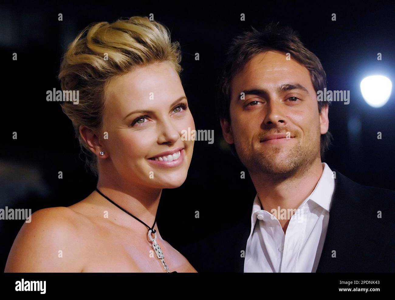 Charlize Theron, left, star of the new film "North Country," arrives ...