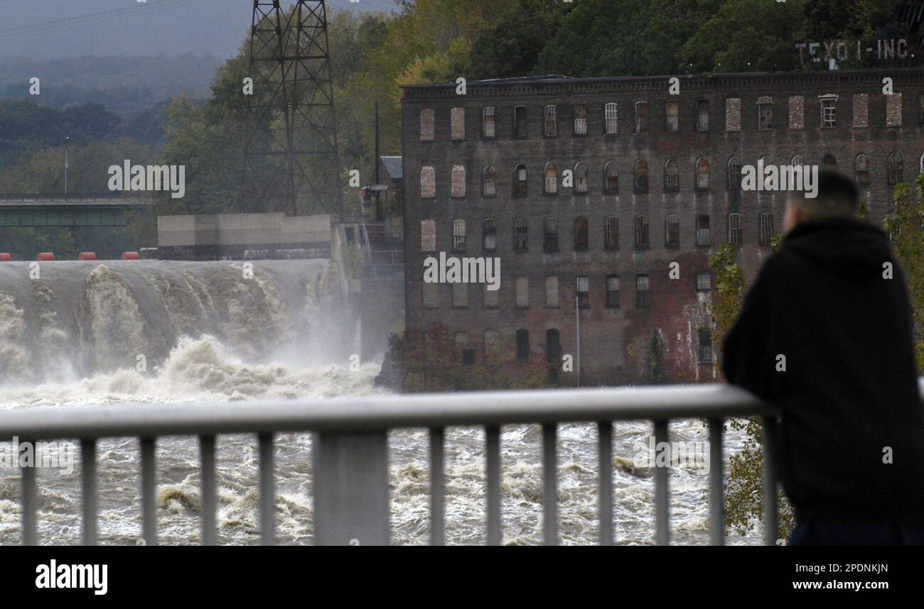 An onlooker takes in the rushing Connecticut River water as it flows ...