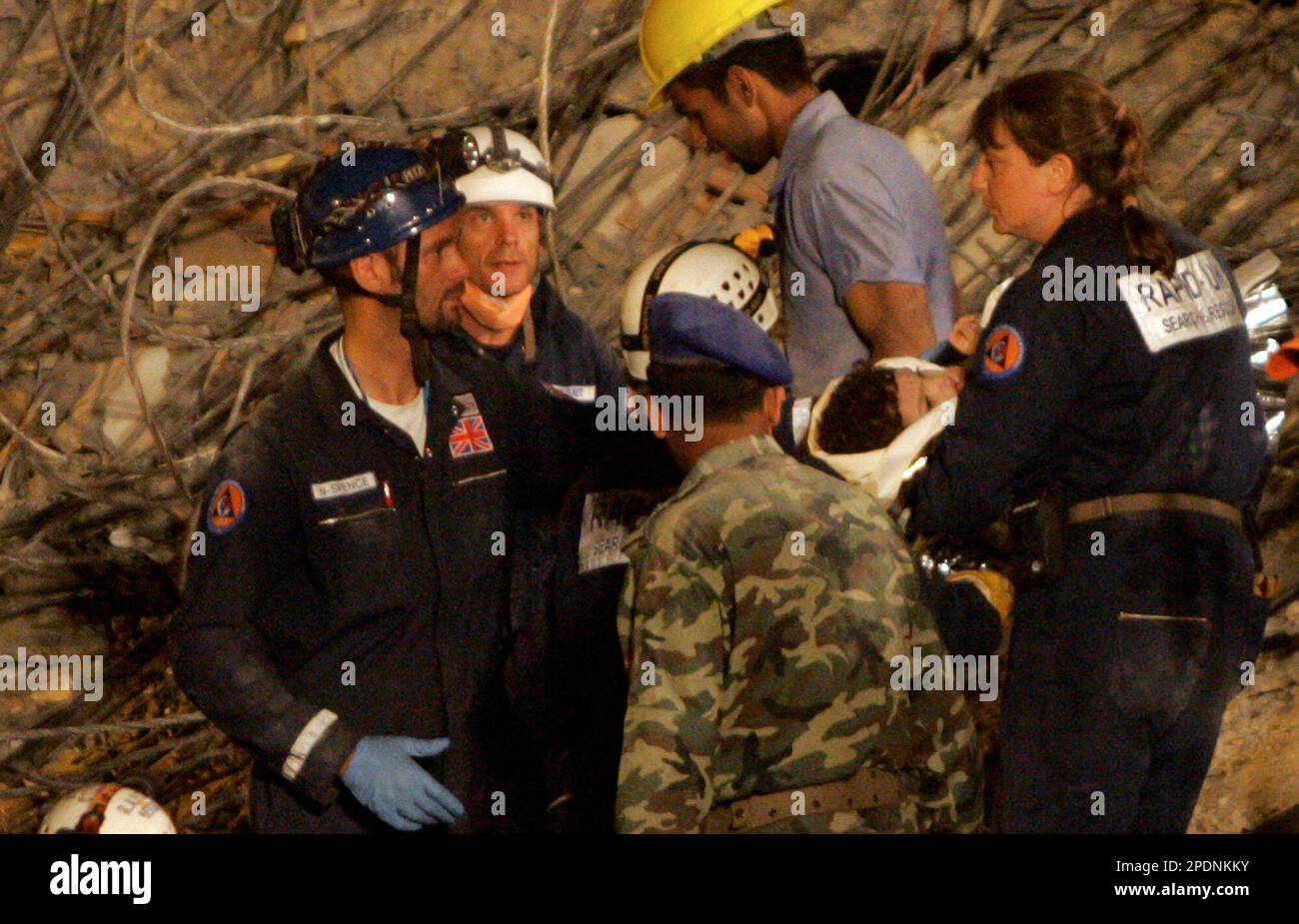 A woman, right, of the British 'RAPID UK Search and Rescue' team ...