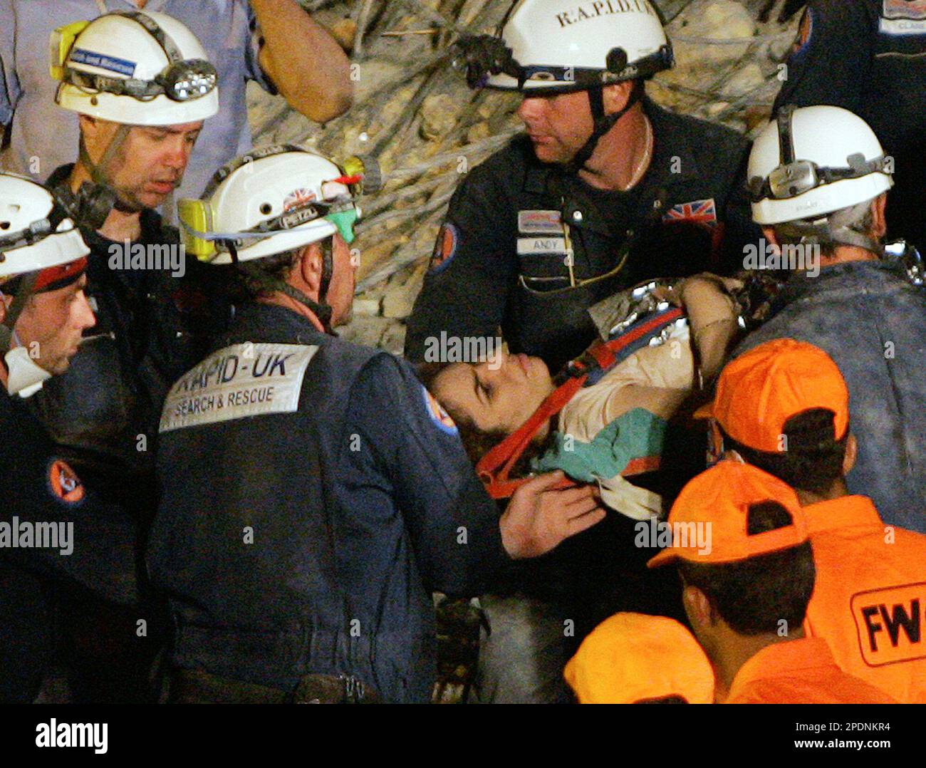 Rescue workers of British 'RAPID UK Search and Rescue' team carry an ...