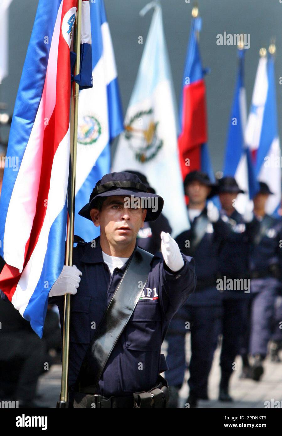 Police from the Federal Investigation Agency (AFI) carry the flags of ...